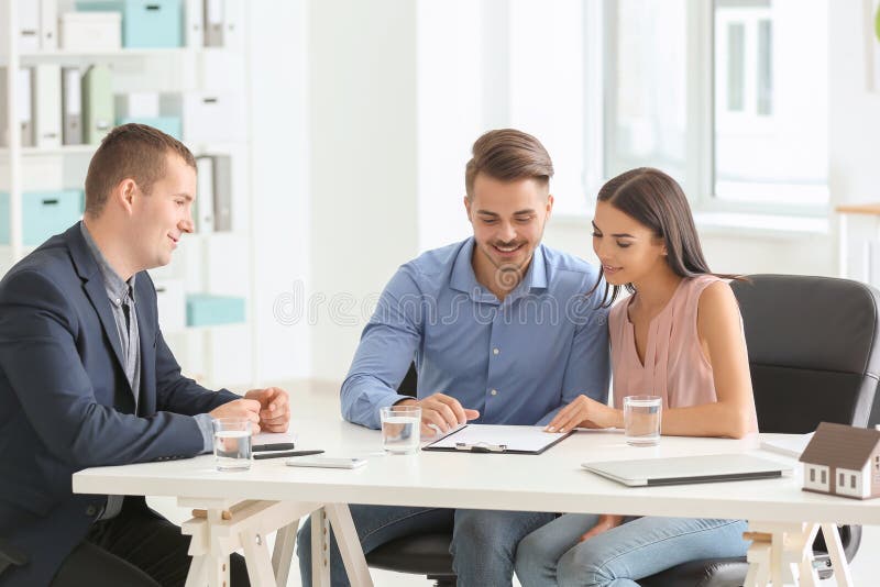 Real Estate Agent Working with Clients in Office Stock Image - Image of ...