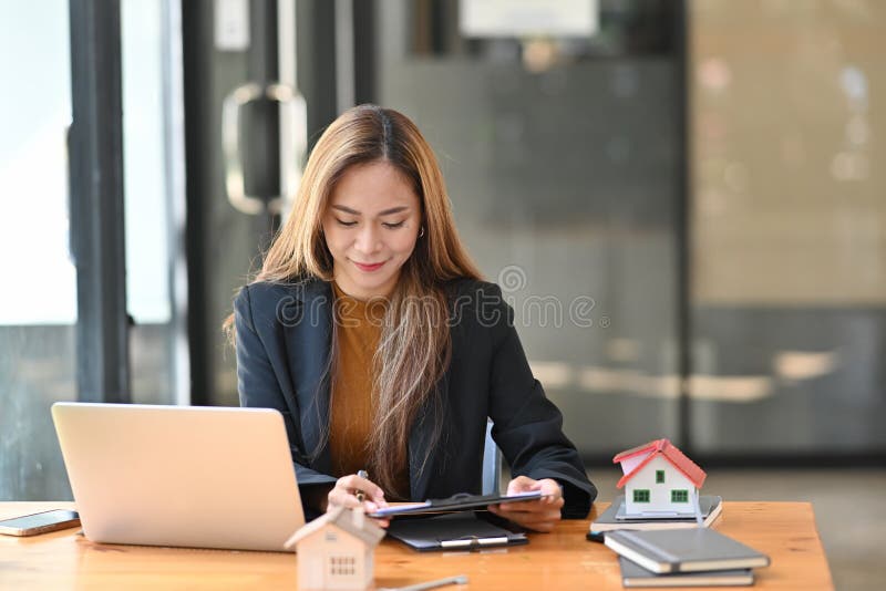 Real Estate Agent Working with Computer Laptop in Office. Stock Image ...