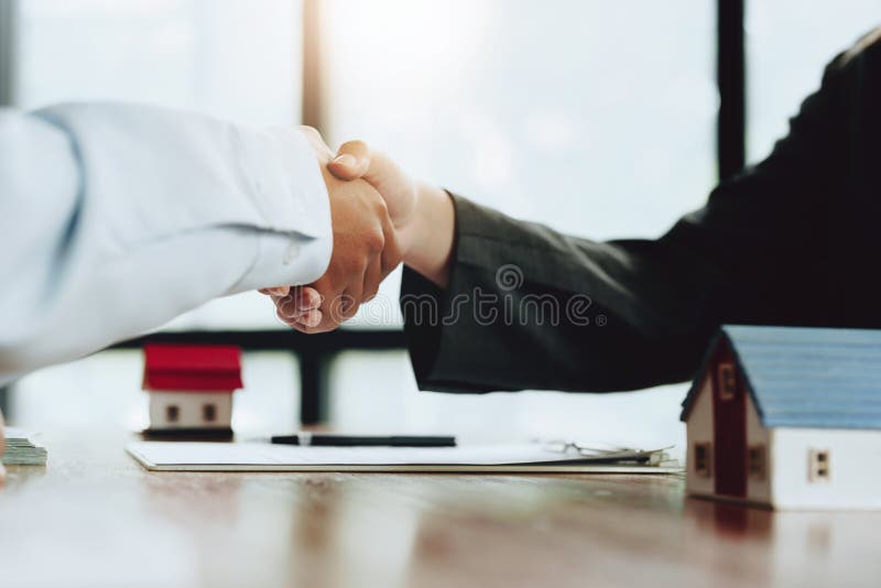 Real Estate Agents Shake Hands with Customers after Signing Documents ...