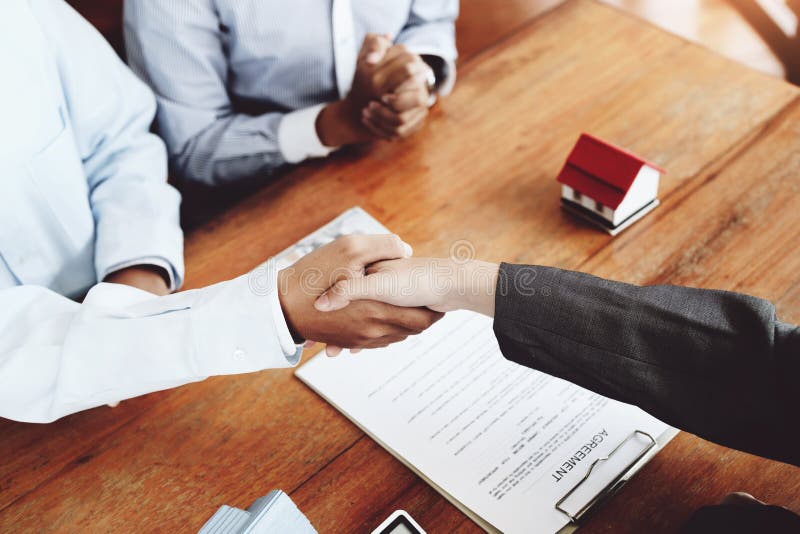 Real Estate Agents Shake Hands with Customers after Signing Documents ...