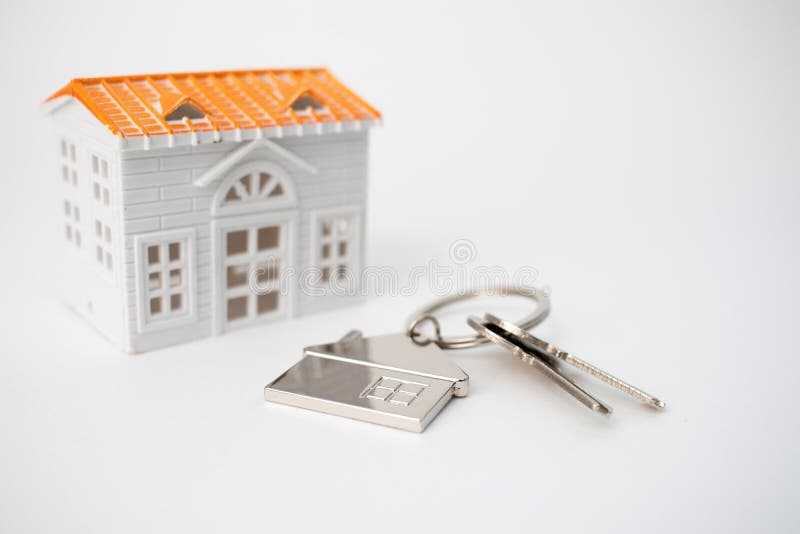Real Estate Concept. House Model and Keys with a Keychain in the Shape ...