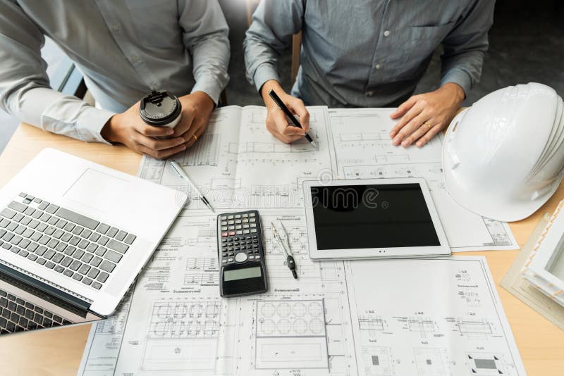 Real-estate Concept, Two Engineer and Architect Discussing Blueprints ...
