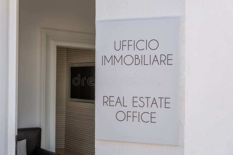 Real Estate Office Signboard in Italian on a White Wall Stock Image ...