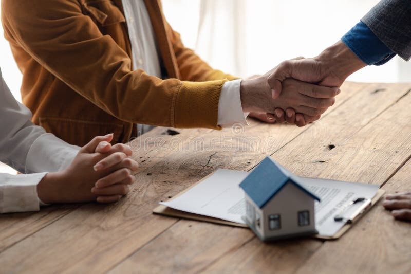 Real Estate Sales Agents Shake Hands with Customers of Housing Projects ...