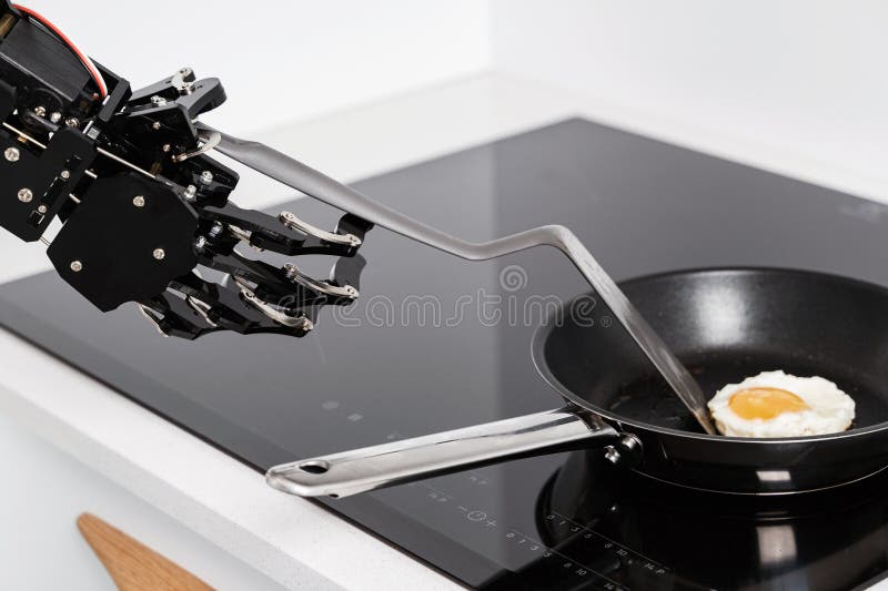 Real Robot Hand and Frying Pan with Fried Egg. Concepts of AI ...