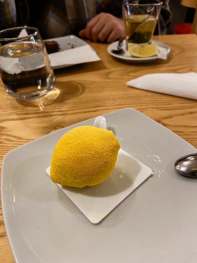 Realistic Lemon-shaped Dessert Served Elegantly on a White Plate at a ...