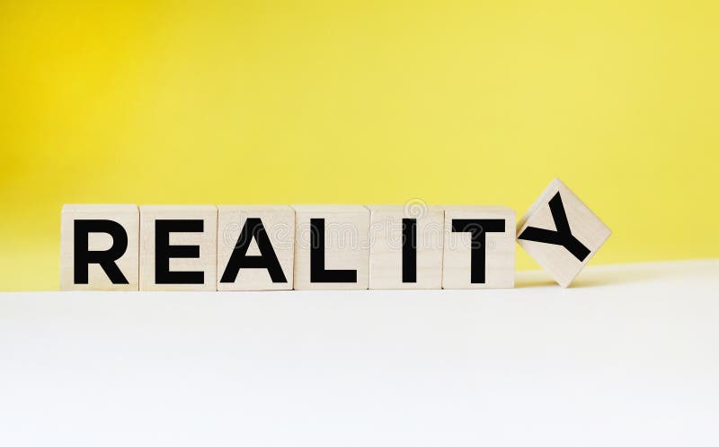 REALITY - Word on Wooden Cubes on a White and Yellow Background ...