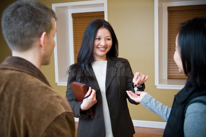 Realtor giving key stock photo. Image of suit, cheerful - 4224024