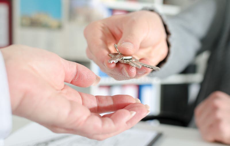 Realtor Handing the Keys To His Client Stock Photo - Image of female ...