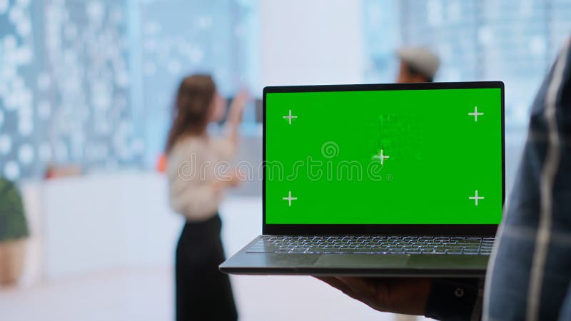 Realtors and Client Evaluating Blueprints Next To Green Screen Display ...