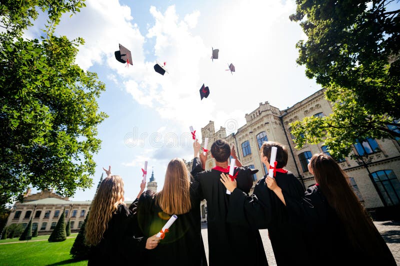 Rear Portrait of Group Students Throwing Mortarboard Graduation ...