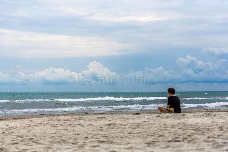 Rear Shot of a Man Sitting on the Sandy Beach Stock Photo - Image of ...