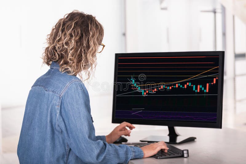 Rear Side View of an Unrecognizable Woman in Office Using Computer with ...