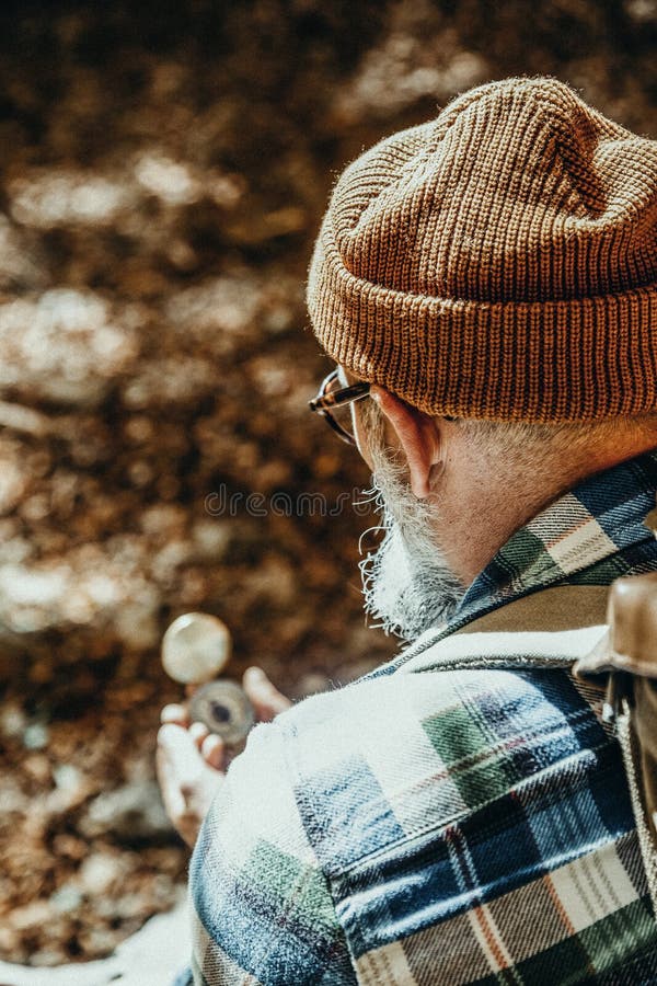 Rear View of an Adventurous Man Consults His Manual Compass on a Sunset ...