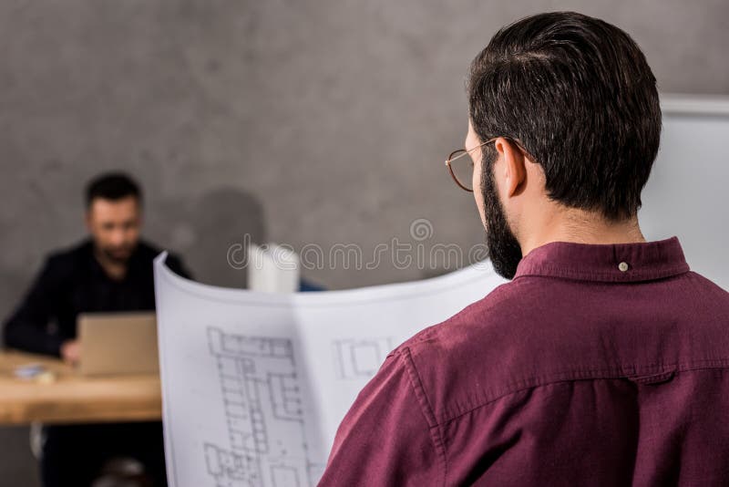 Rear View of Architect Looking at Blueprint Stock Photo - Image of ...