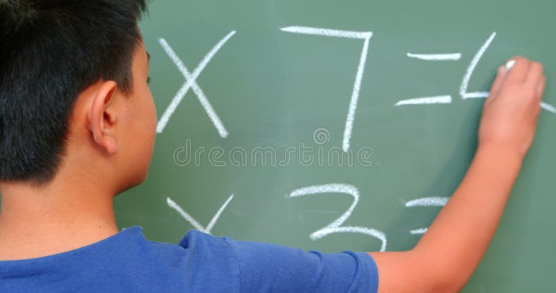 Rear View of Asian Schoolboy Solving Math Problem on Chalkboard in ...