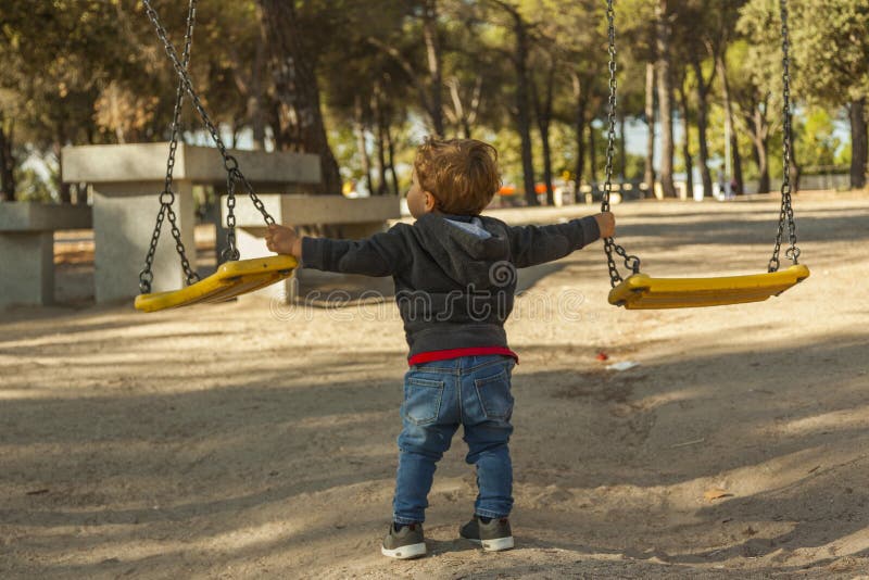 Rear View Boy Having Fun with the Swing at the Playground Stock Photo ...