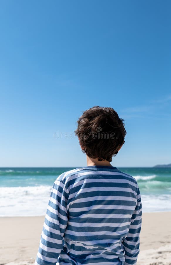 Rear View of a Boy Looking To the Sea, Vertical Image Stock Photo ...