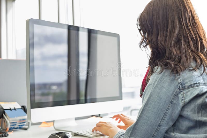 Rear View of Businesswoman Using Desktop Computer in Creative Office ...