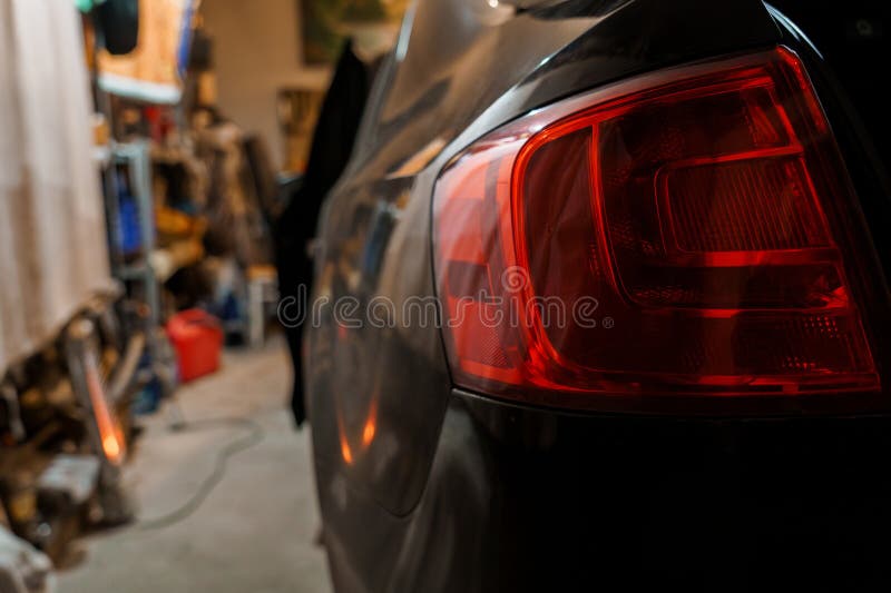 Rear View of a Car Tail Light in a Dimly Lit Garage Setting Stock Photo ...