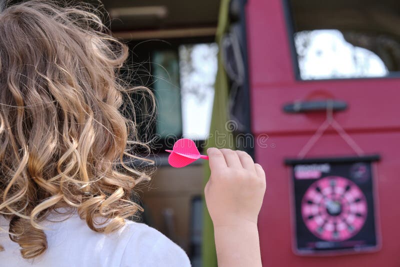 Rear View of a Child Playing Darts on Vacation. Stock Image - Image of ...