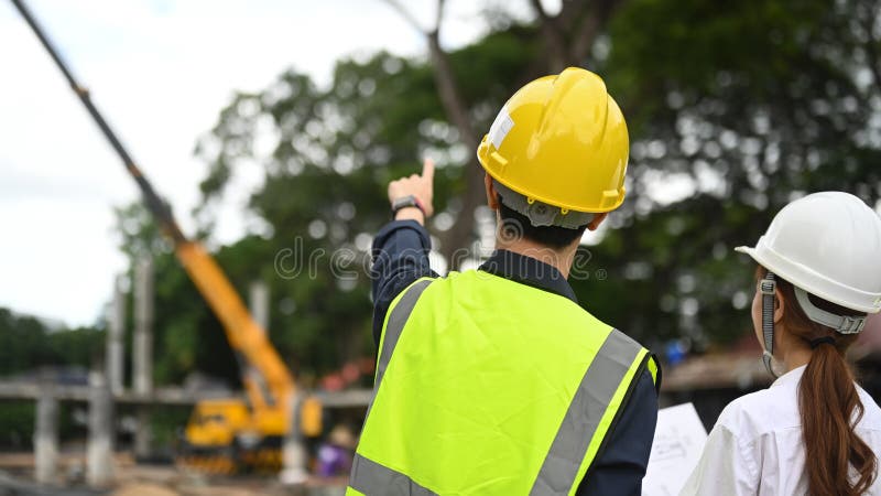 Rear View of Civil Engineers and Specialists Checking Plan at ...