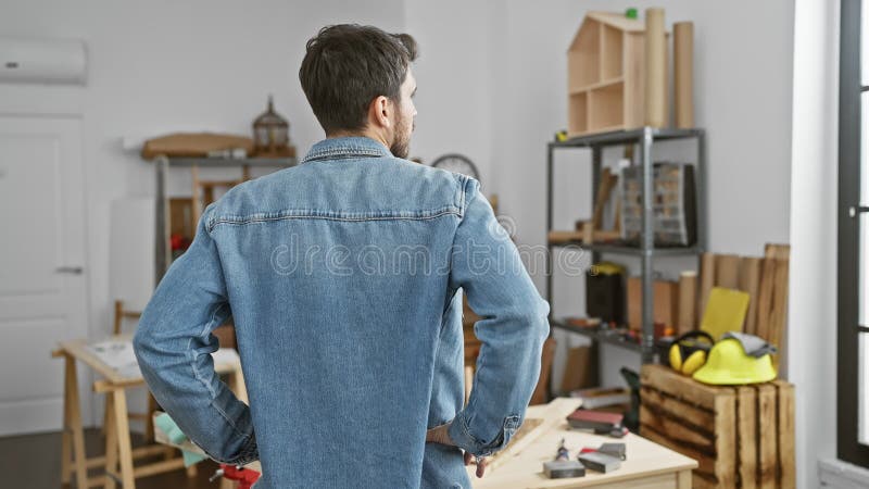 Rear View of a Contemplative Man Wearing a Denim Jacket Standing in a ...