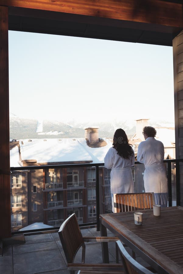 Couple Looking At View From Balcony Stock Photo - Image of lake, nature ...