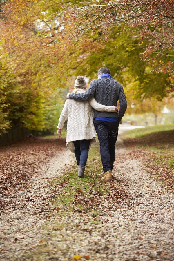 Rear View of Couple Walking Along Autumn Path Stock Photo - Image of ...