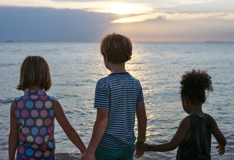 Rear View of Diverse Kids Standing at the Beach Together Stock Image ...