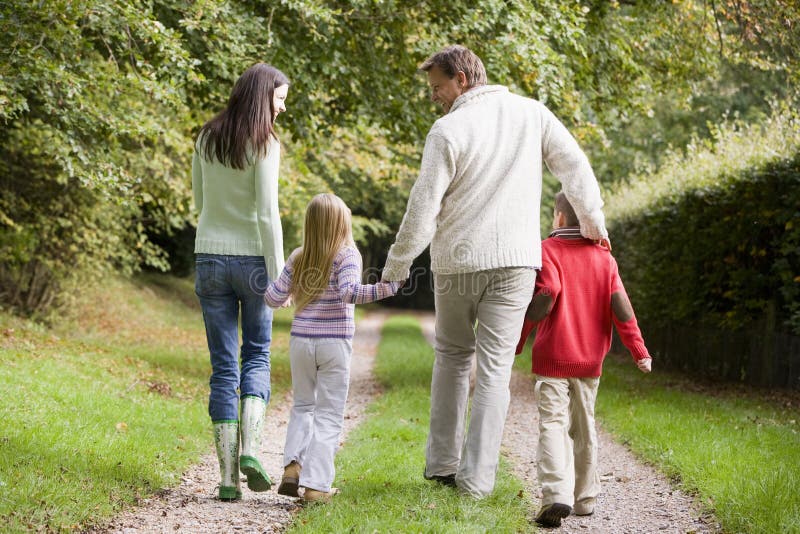 Rear View of Family Walking Along Track Stock Image - Image of female ...