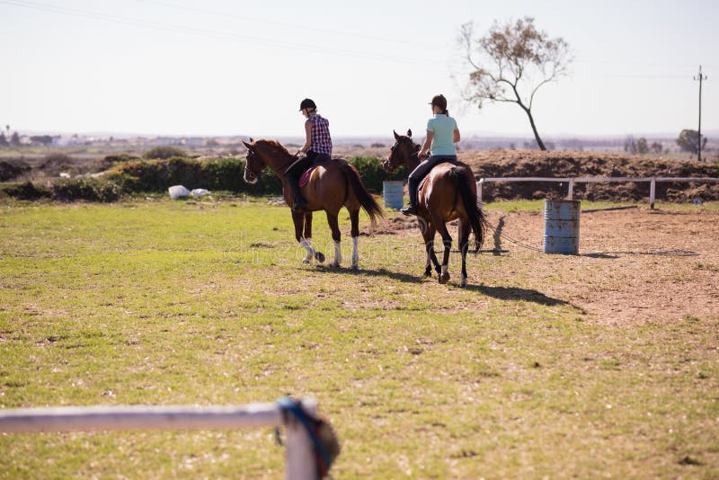Rear View of Female Friends Horseback Riding Stock Image - Image of ...