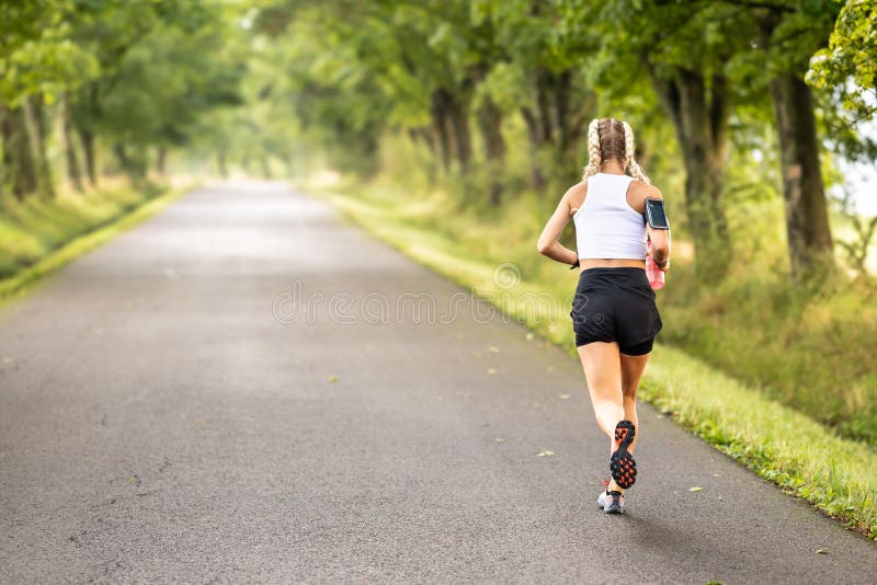 Rear View of a Female Runner Training in Nature Stock Photo - Image of ...