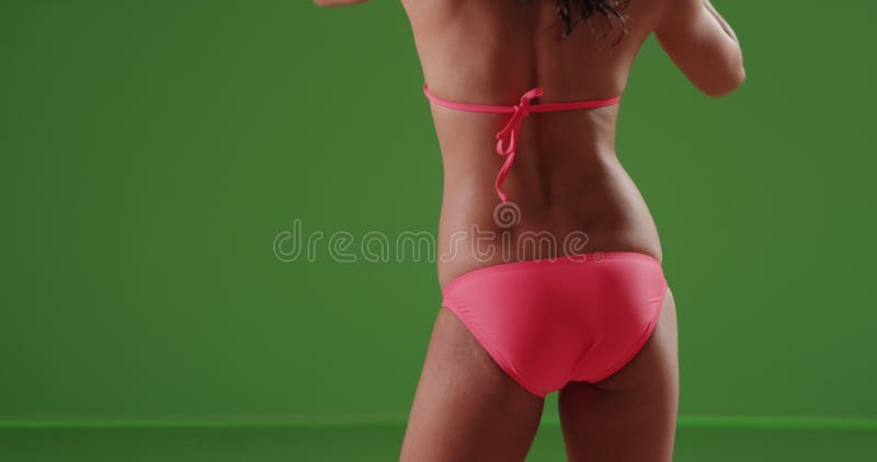 Rear View of Fit Woman in Swimsuit Looking at Beautiful on Green Screen ... Rear View of Fit Woman in Swimsuit Looking at Beautiful on Green Screen ...