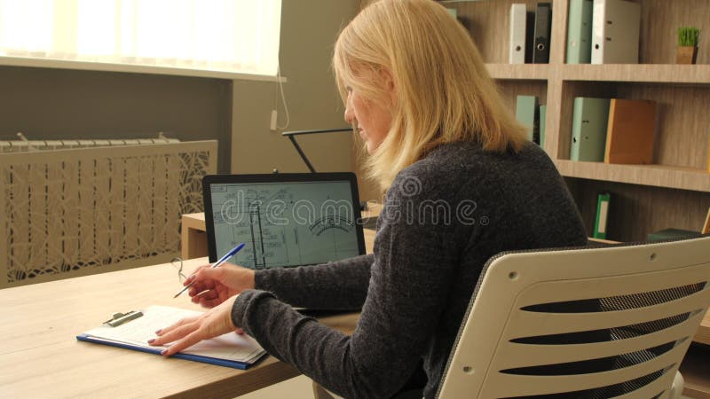 Rear View of Middle Aged Woman Engineer Working with Laptop on Project ...