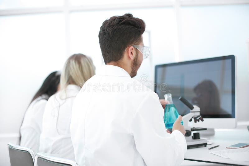 Rear View.a Group of Scientists Working in a Modern Laboratory Stock ... Rear View.a Group of Scientists Working in a Modern Laboratory Stock ...