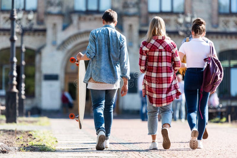 Rear View of Group of Teen Students Walking in Front of Old Stock Photo ...