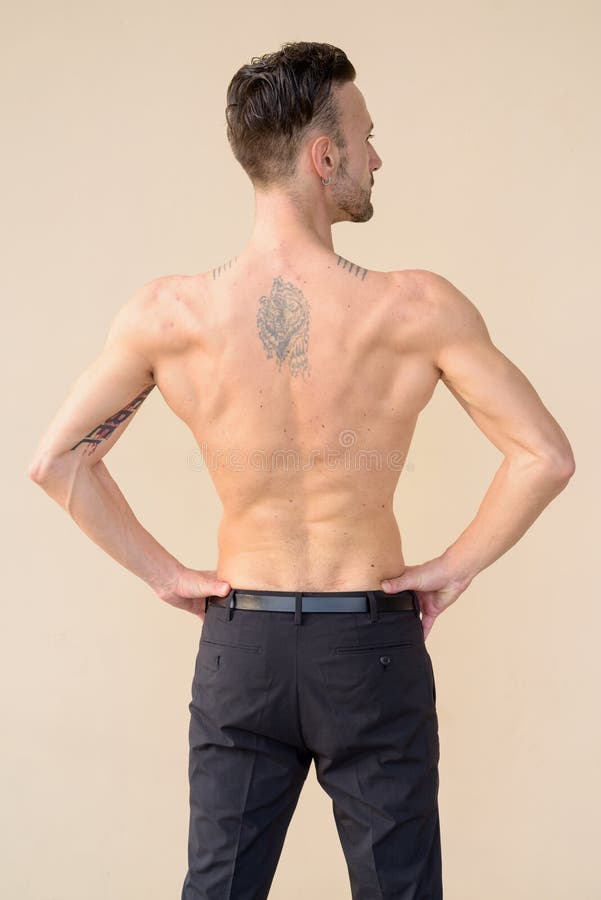 Rear View of Handsome Young Man Back Shirtless Against Wall Stock Photo ...