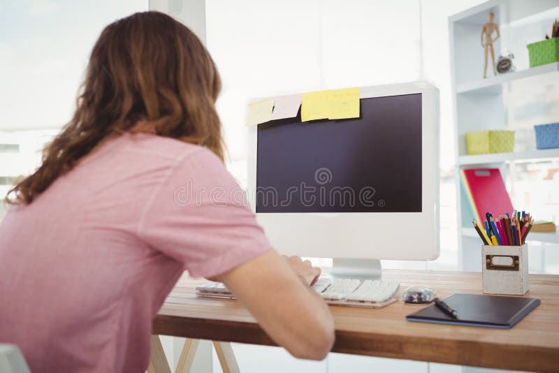 Rear View of Hipster Working on Computer Stock Photo - Image of ...