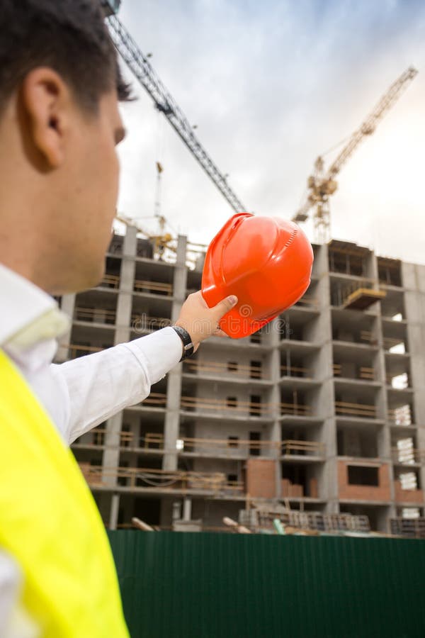 Rear View Image of Construction Engineer Pointing at Building Si Stock ...