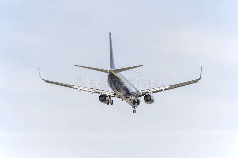 Rear View of a Jet Airplane with Landing Gear Deployed Approaching the ...