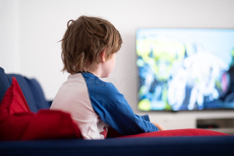 Little Boy Sitting on a Sofa Watching TV Stock Image - Image of ...