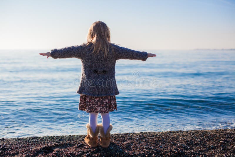 Rear View of Little Girl on the Beach Having Fun Stock Photo - Image of ...