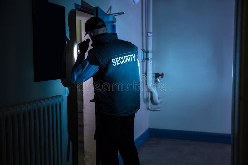 Rear View of a Male Security Officer with Flashlight Stock Image ...