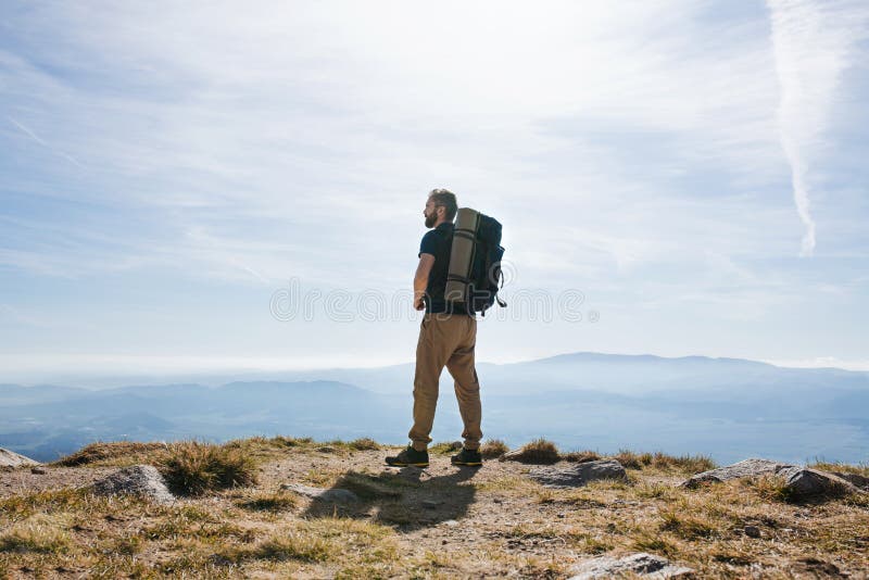 Rear View of Man with Backpack Hiking in Mountains in Summer. Stock ...