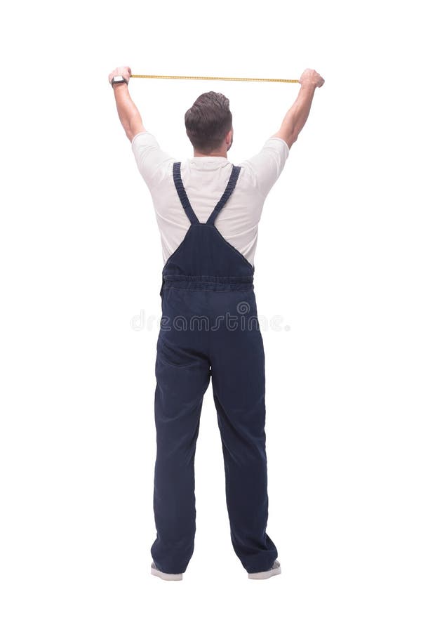 Rear View. a Man Measuring Something with a Construction Tape Measure ...