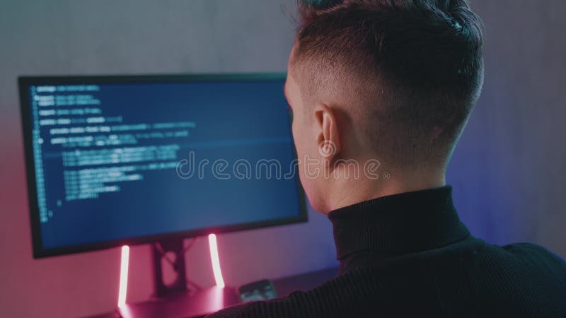 Programmer Coding On A Computer In The Dark With A View Of The Lights 2331
