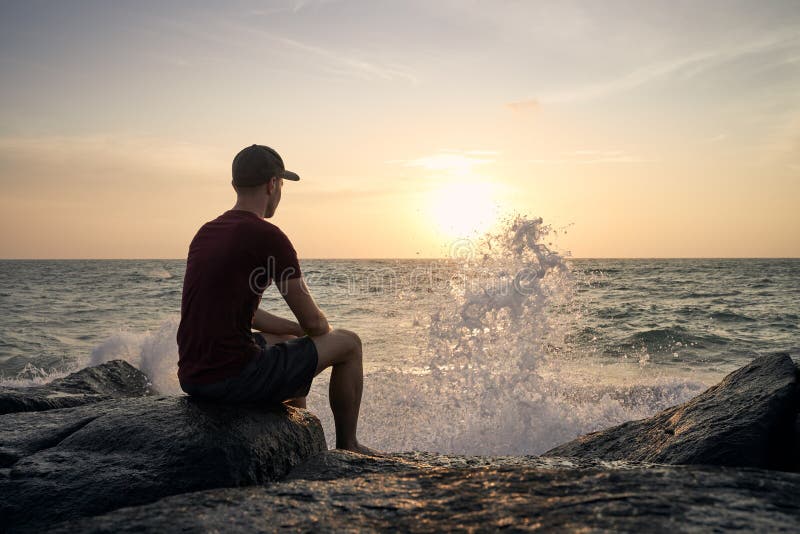 Man Sitting on Rock and Watching Sunset Stock Photo - Image of lonely ...