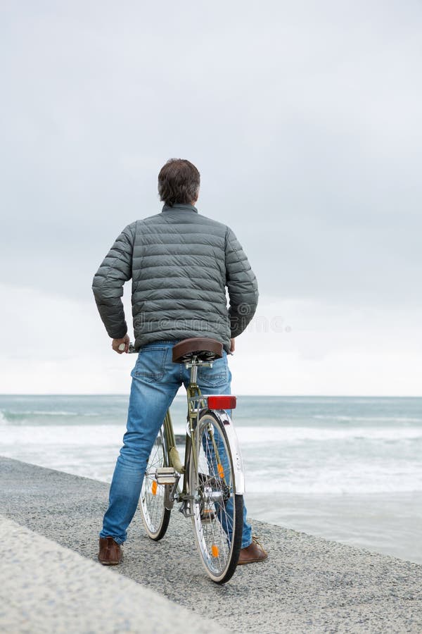 Rear View of Man Standing on Bicycle Stock Image - Image of bicycle ...