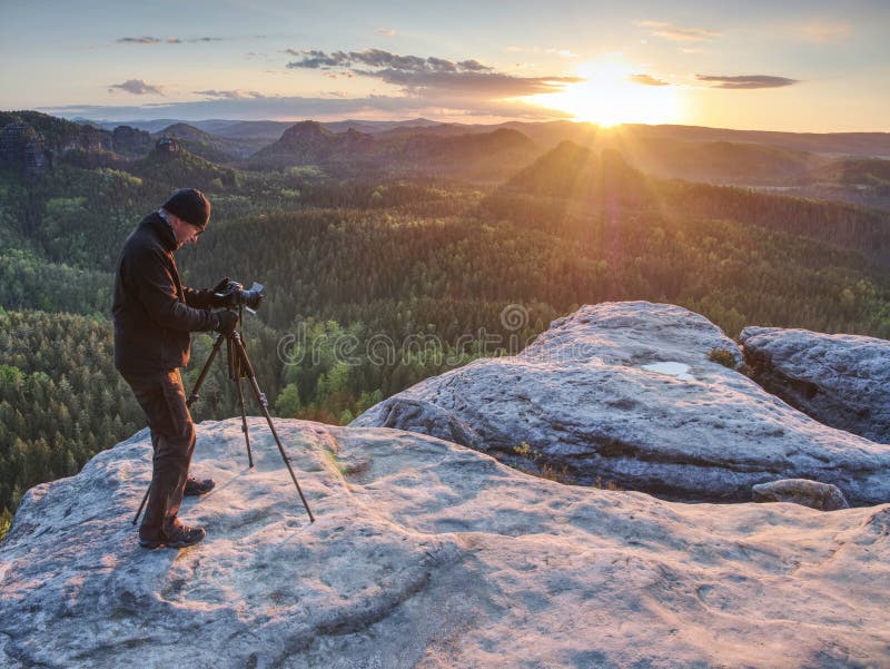 Rear View of Man Taking Picture with Camera in the Wildy Rocky Resort ...